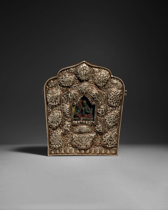 Bonhams : A LARGE SILVER ALLOY REPOUSSÉ GAU WITH A TSATSA OF GREEN TARA ...