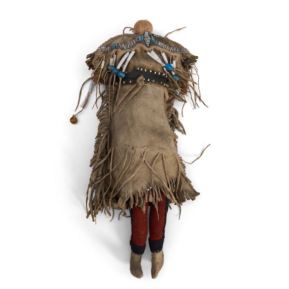 Bonhams Skinner : A Plains beaded hide doll lg. 11 1/2 in.