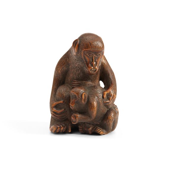 Bonhams Skinner : A WOOD NETSUKE OF A MONKEY WITH BABY