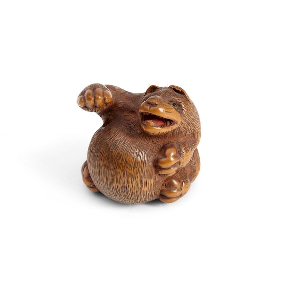 Bonhams Skinner : A WOOD NETSUKE OF A TANUKI