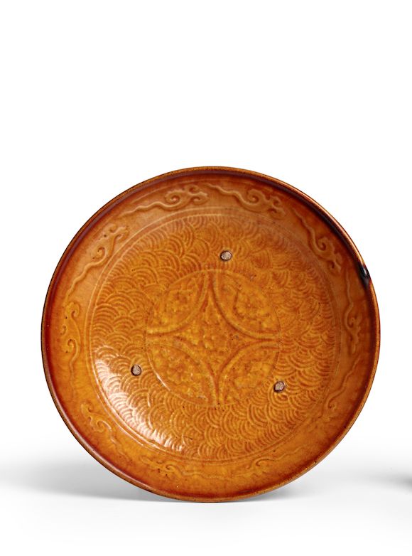 Bonhams : A MOLDED AMBER-GLAZED DISH Liao Dynasty