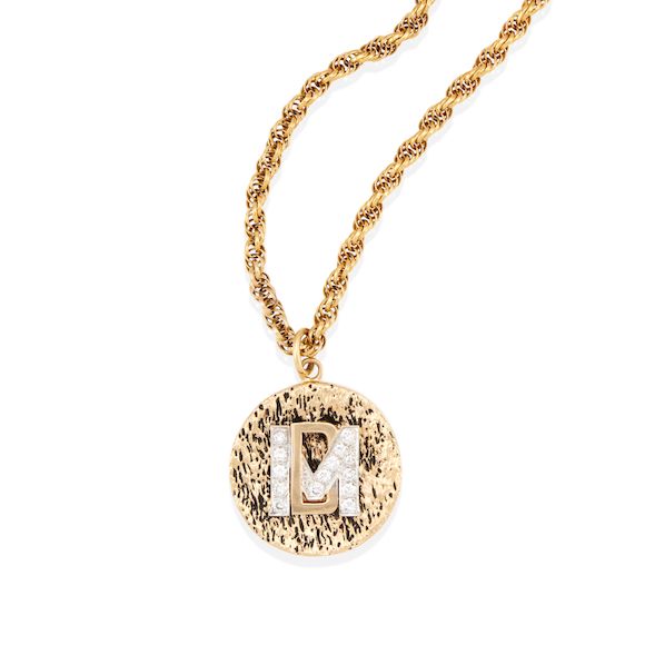 Bonhams : A 14K BI-COLOR GOLD AND DIAMOND DM PENDANT NECKLACE