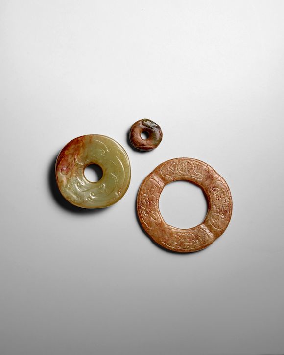 Bonhams : THREE ARCHAISTIC CARVED JADE BI DISCS Late Qing Dynasty