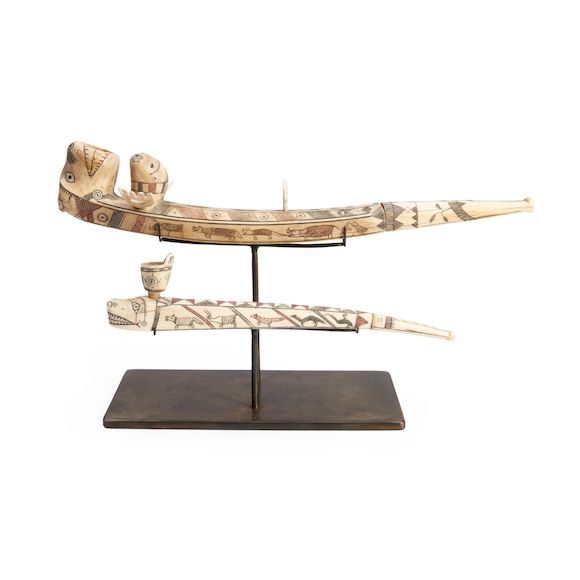 Bonhams Skinner : A pair of Eskimo scrimshaw pipes lg. 13, and 9 in.