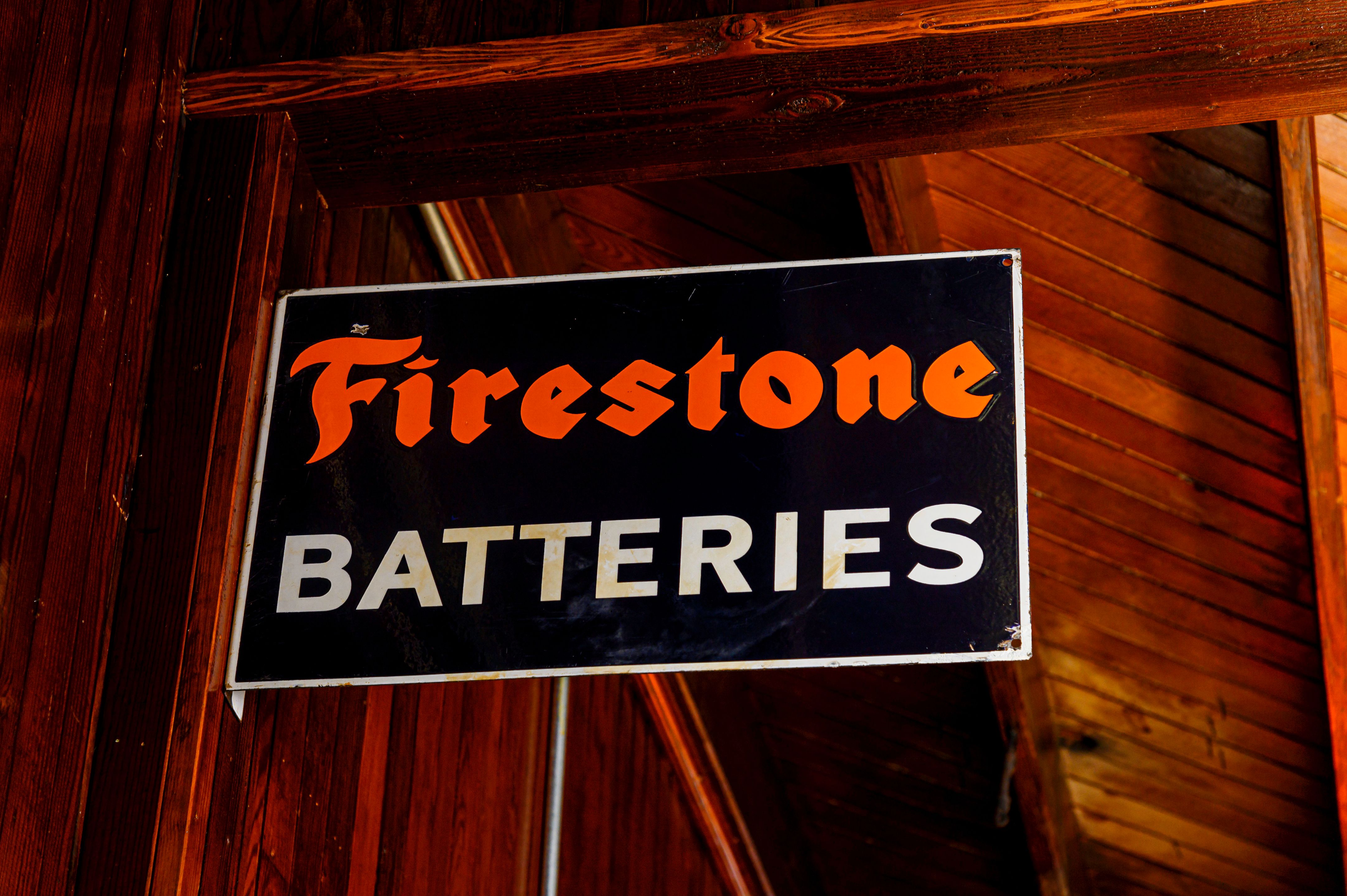 Bonhams Cars : A Wall-Mounted Firestone Batteries Sign
