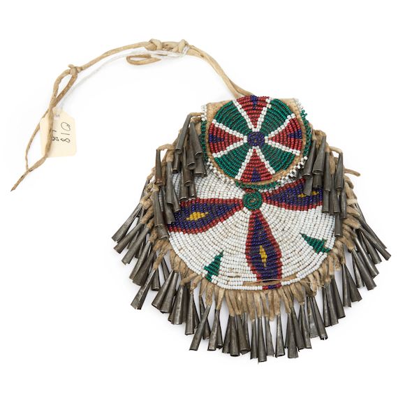 Bonhams Skinner : An Apache beaded hide pouch ht. 5 1/2, wd. 4 1/4 in. including tin cones.