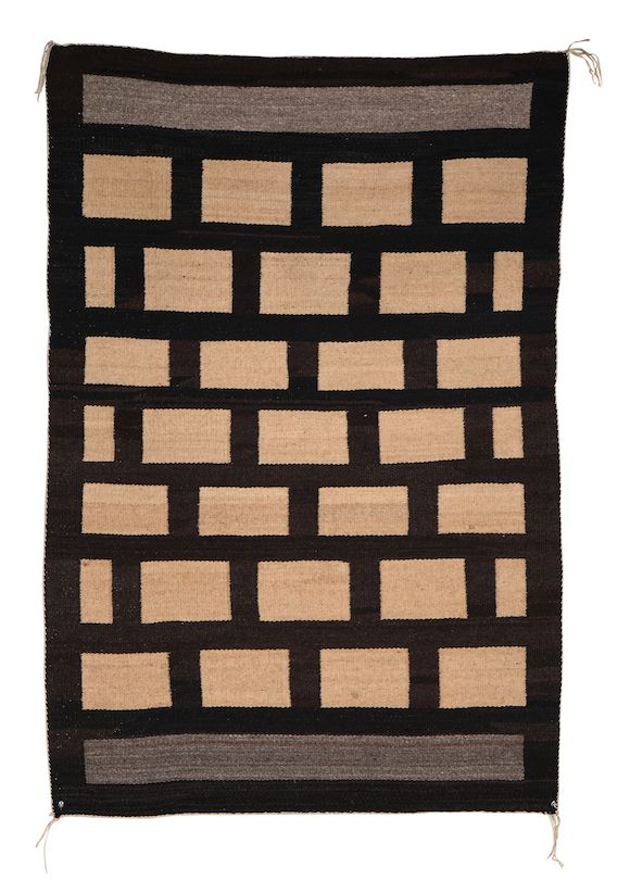 Bonhams Skinner : A Diné (Navajo) rug 51 1/2 x 35 in.