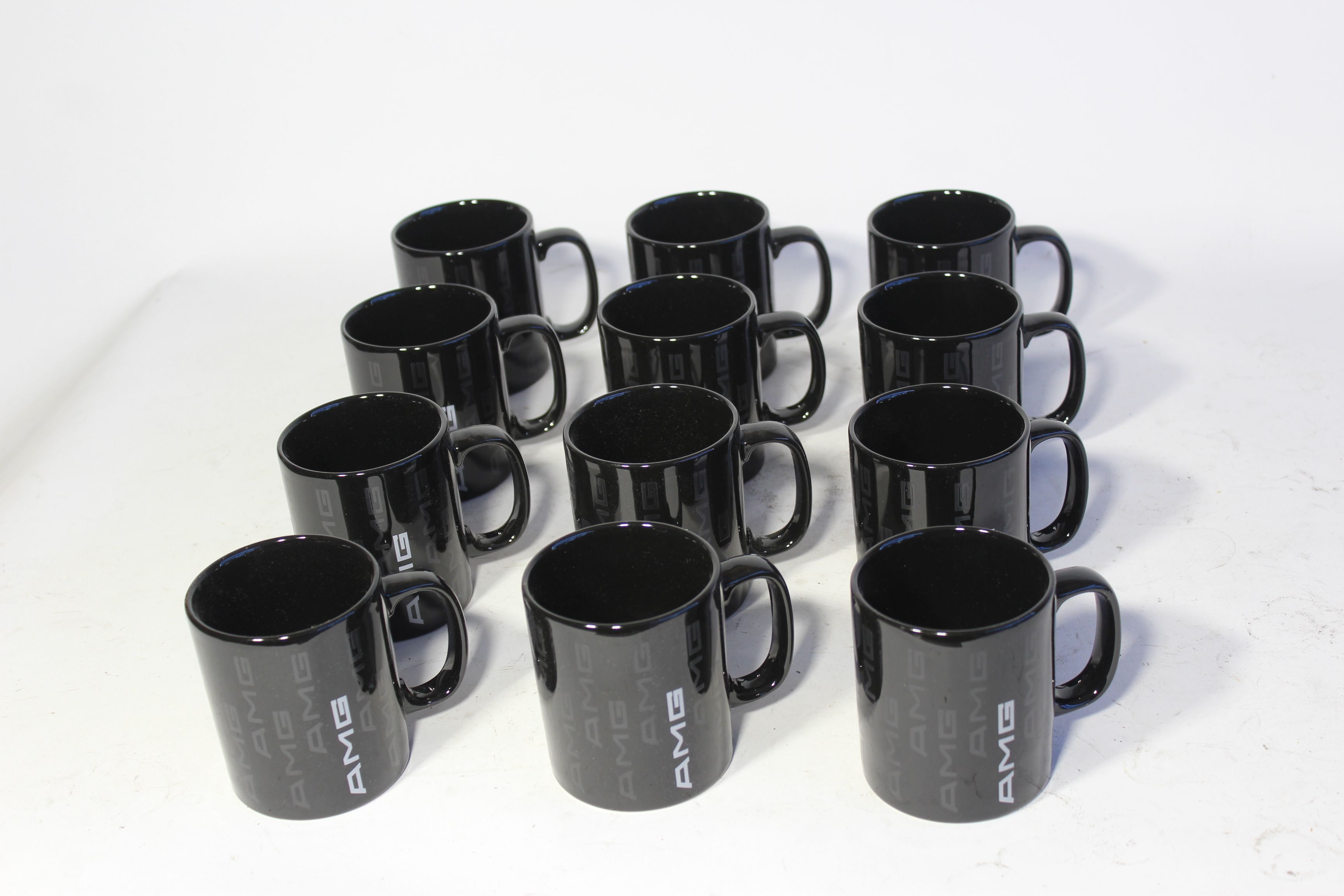 Bonhams Cars : A group of AMG branded coffee mugs,