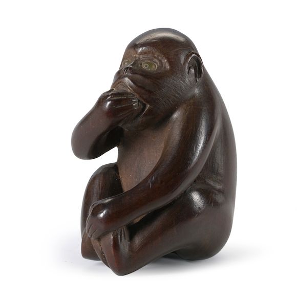 Bonhams Skinner : A WOOD NETSUKE OF A MONKEY Edo period, 19th century