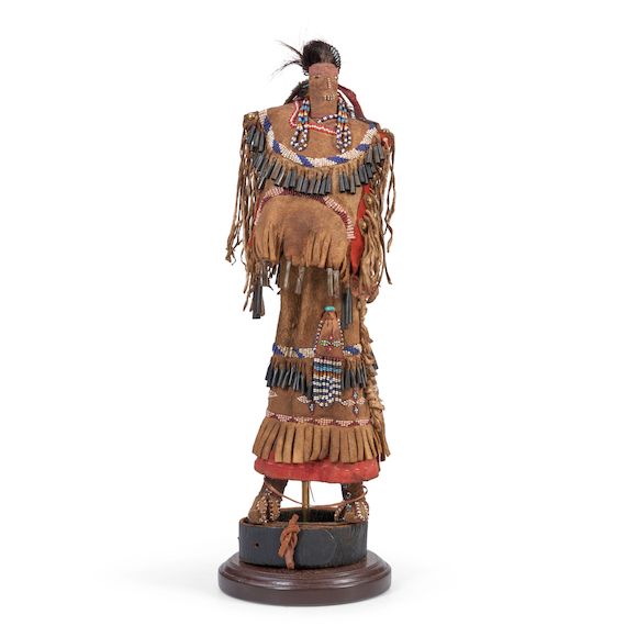 Bonhams Skinner : An Apache beaded hide doll ht. 13 3/4 in.