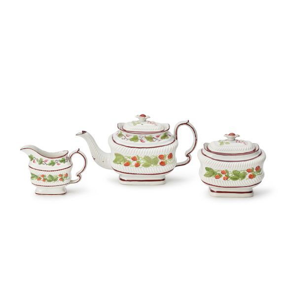 Bonhams Skinner : THREE-PIECE PEARLWARE EMBOSSED STRAWBERRY TEA SET