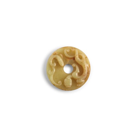 Bonhams : AN ARCHAISTIC YELLOW JADE 'DRAGON' DISC 17th/18th century