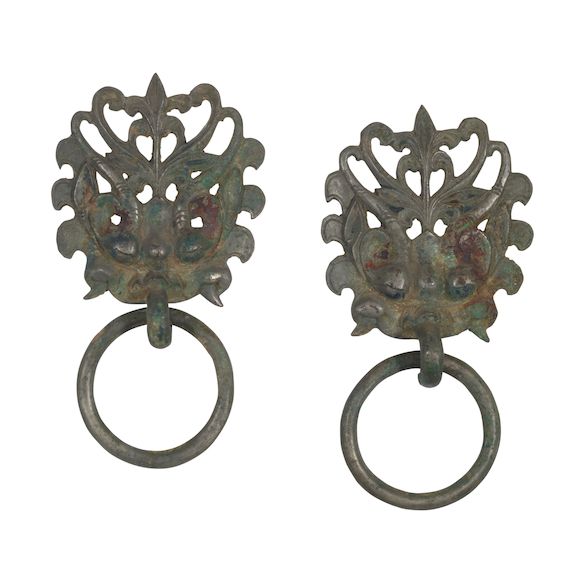Bonhams : A PAIR OF BRONZE OPENWORK TAOTIE MASKS AND RINGS Northern Qi ...