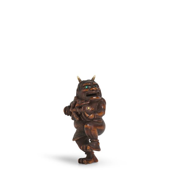 Bonhams : AN INLAID-WOOD NETSUKE OF AN ONI Edo period (1615-1868), 19th ...