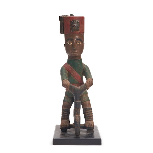 Bonhams Skinner : CARVED AND PAINTED COLON BIKE RIDER