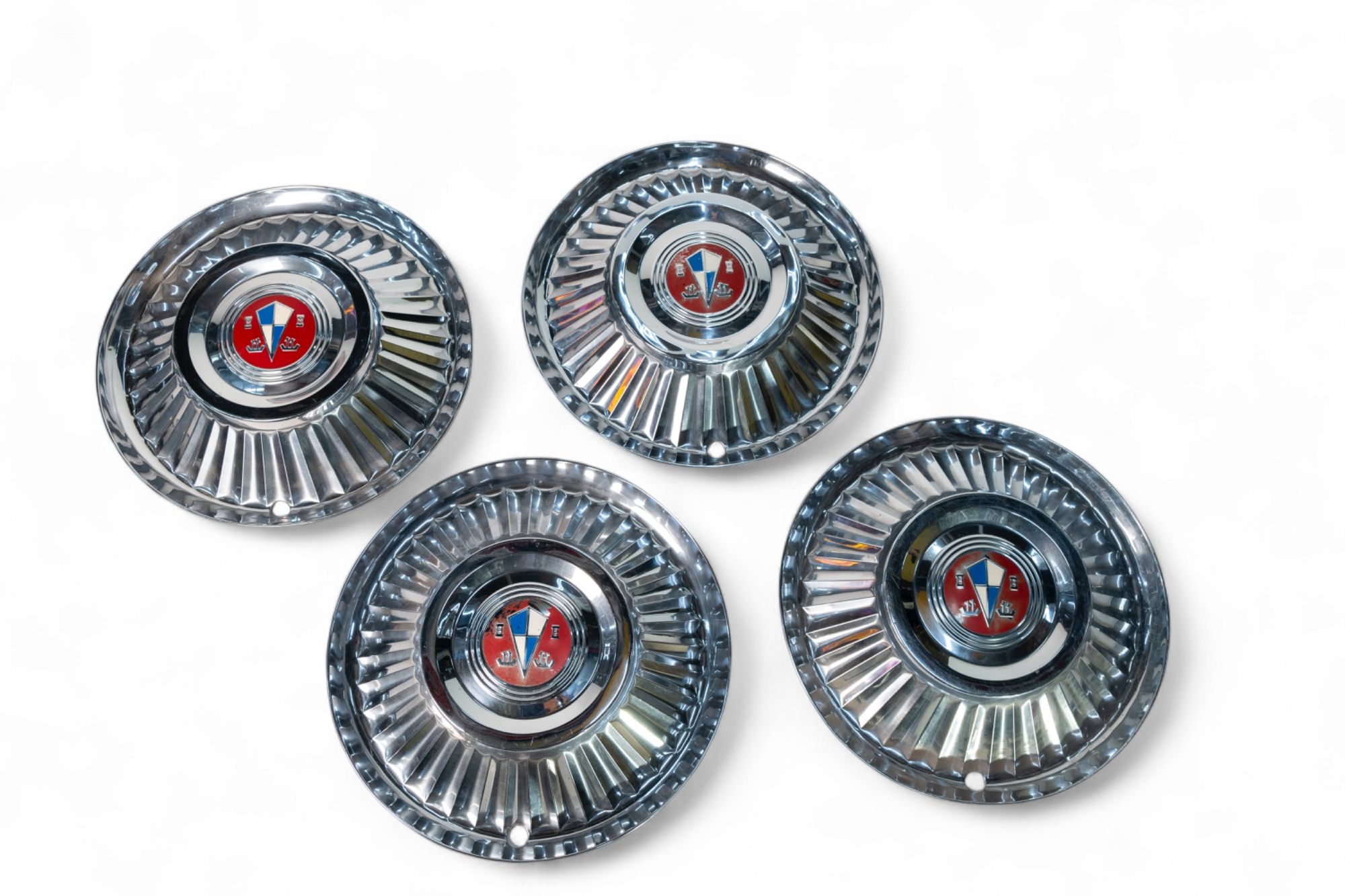 Bonhams Cars : A set of 4 Hudson Hornet Special hub caps,