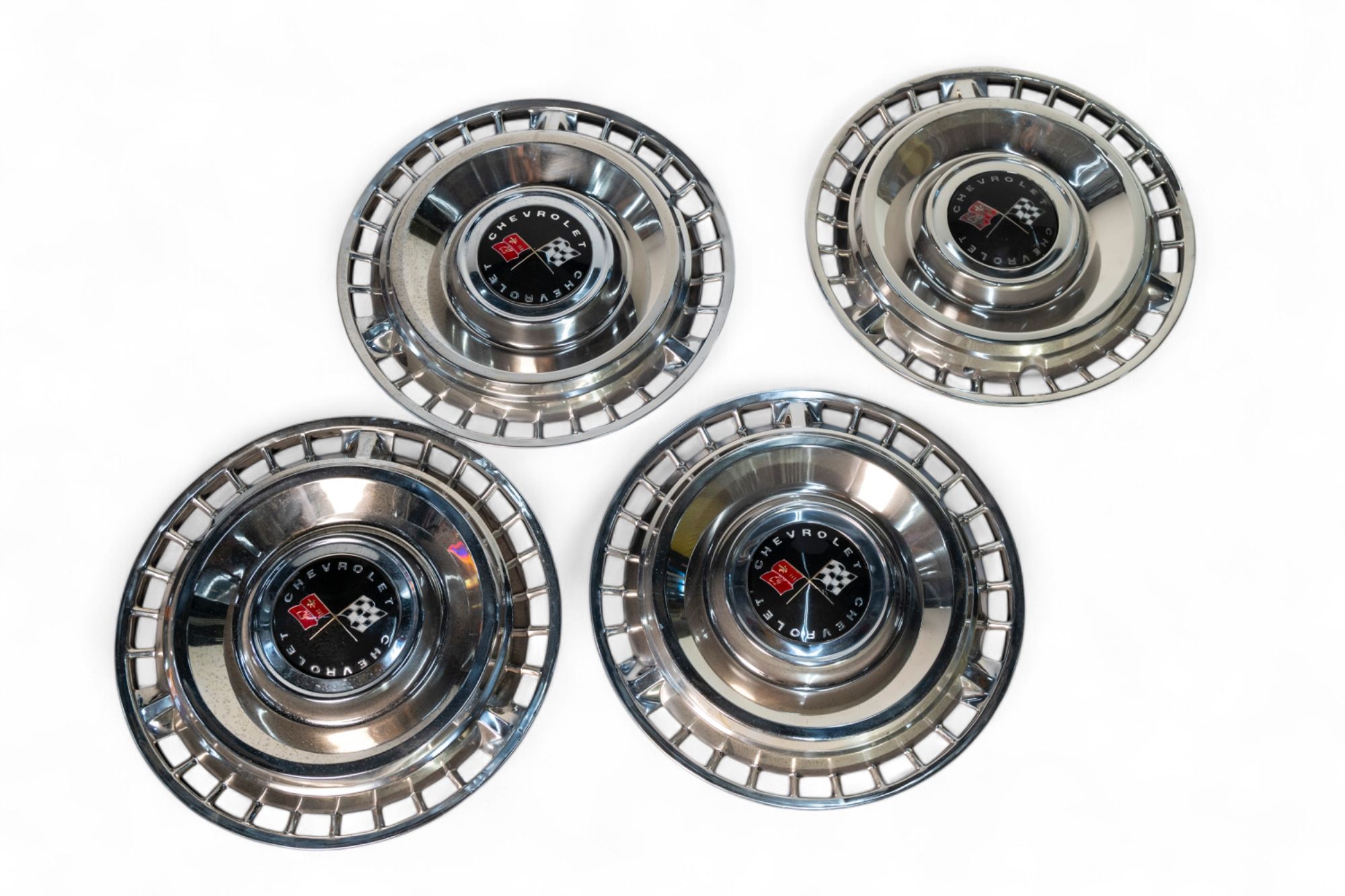 Bonhams Cars : A set of 4, 1961 Chevrolet Impala hub caps,