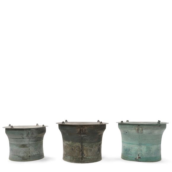 Bonhams : THREE BRONZE MOKO STYLE DRUMS20th century